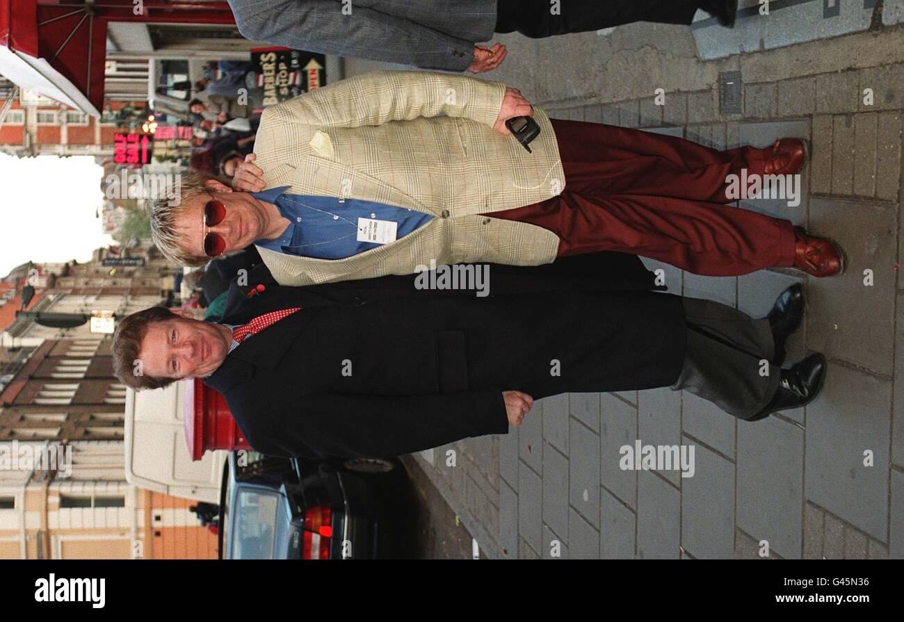 Comedian Jim Davidson (left) arrives with an unidentified friend at ...