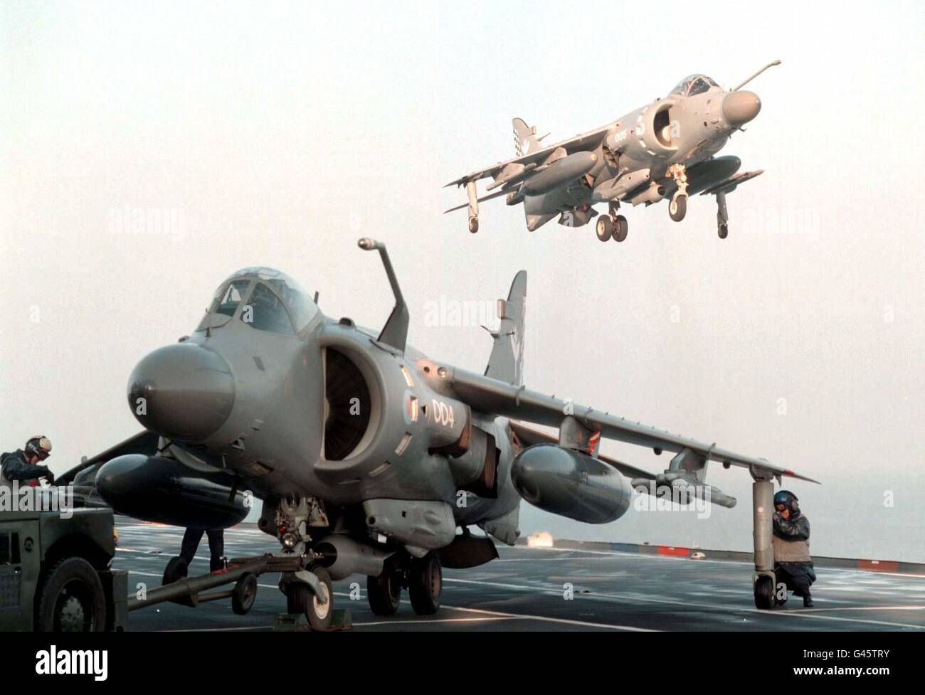 Sea Harriers from RNAS Yeovilton arrive on the deck of HMS Illustrious ...