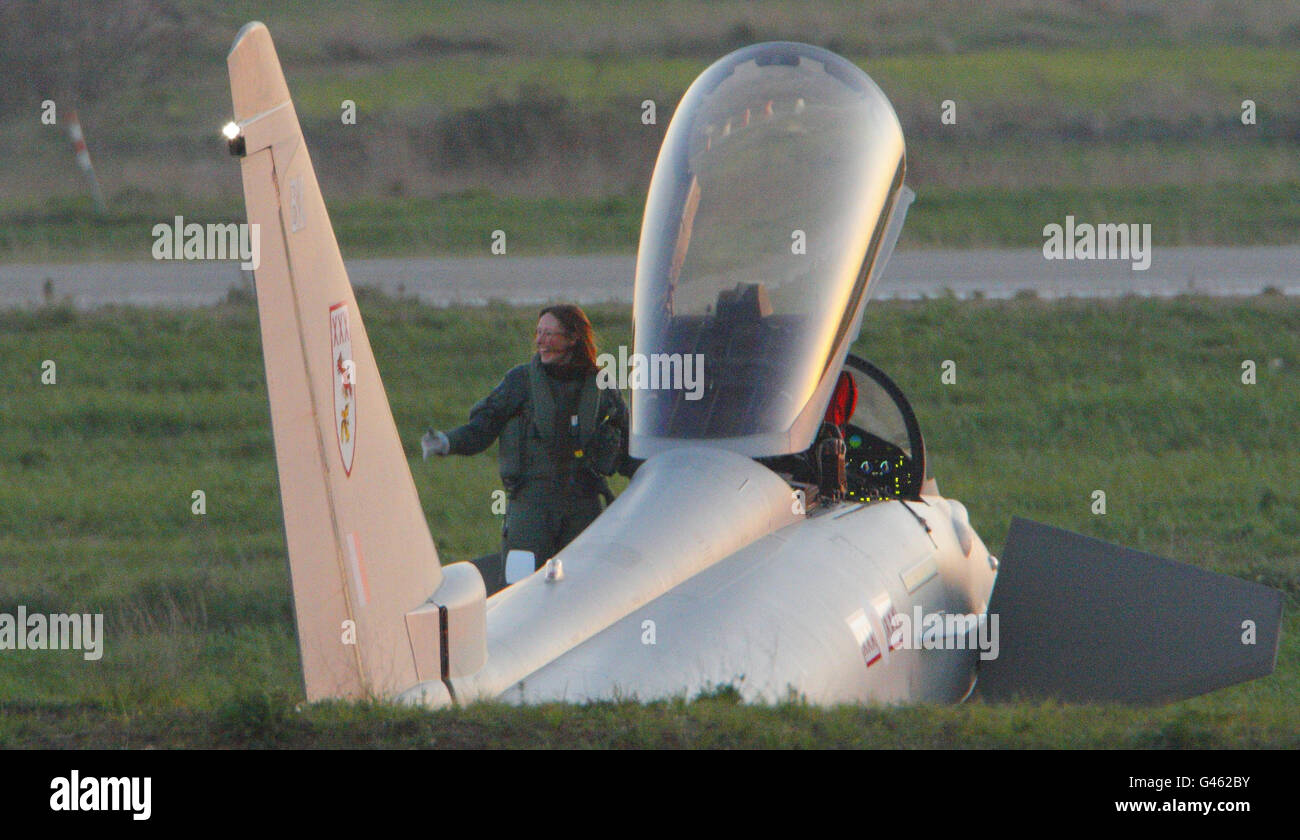 A female RAF Typhoon jet fighter pilot smiles and waves to the ground ...