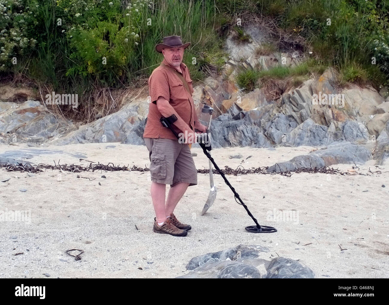 A man uses a metal detector on Towan Beach in Cornwall, Britain June 16 ...