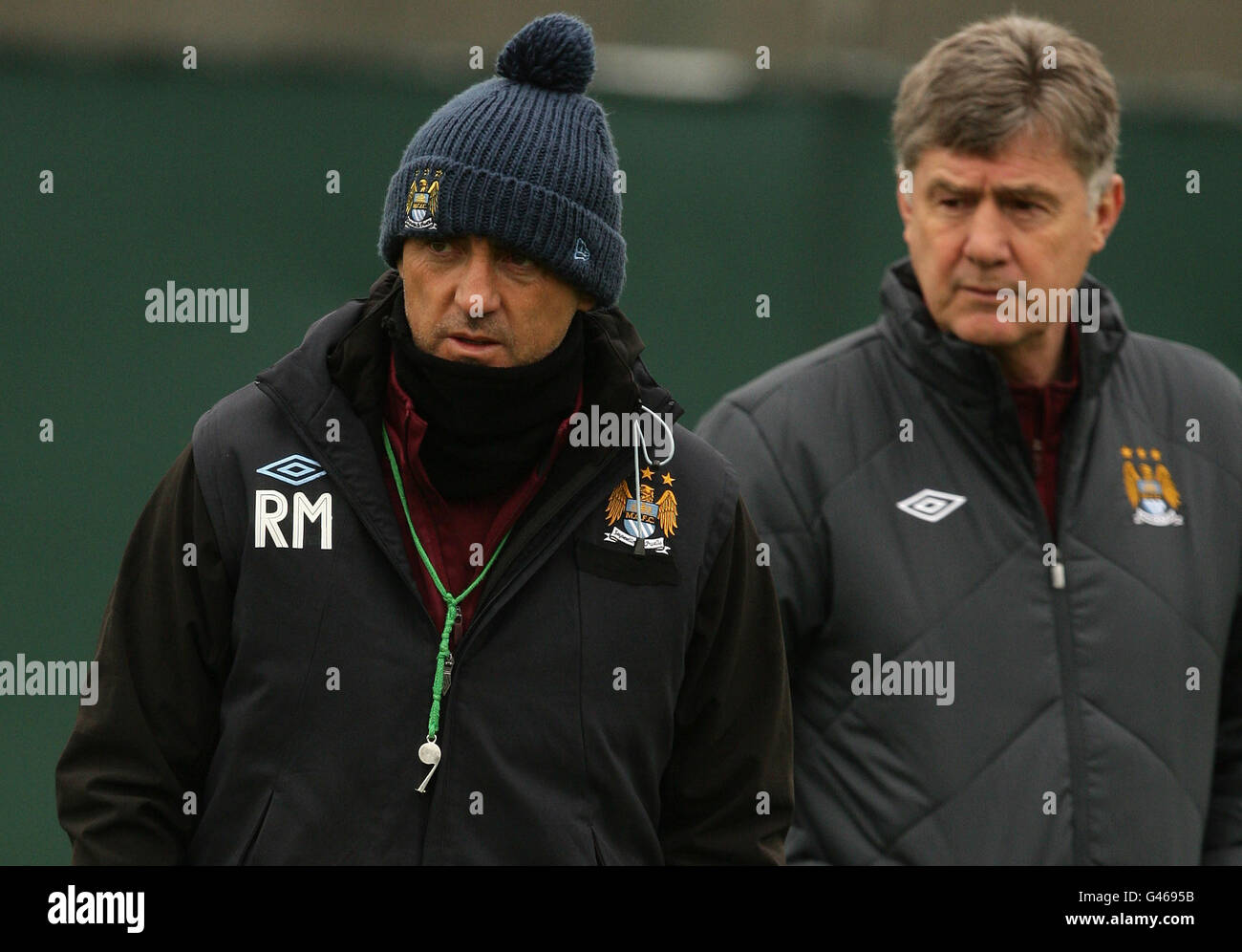 Manchester City's manager Roberto Mancini (left) and his assistant ...