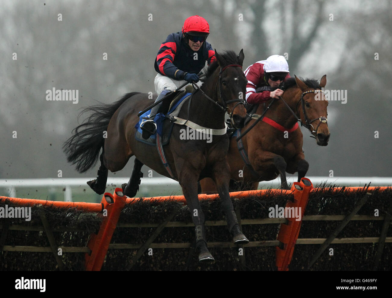 Burnthill ridden by jockey Peter Hatton (red cap) jumps the last fence ...