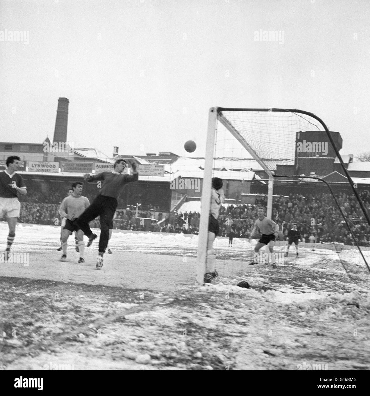 With goalkeeper Dave Underwood (trousers) beaten, the ball is cleared ...