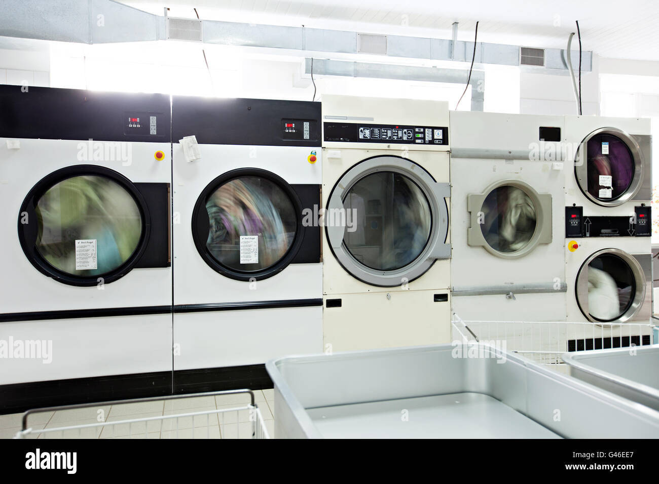 Image of working washing machines in laundry room Stock Photo - Alamy