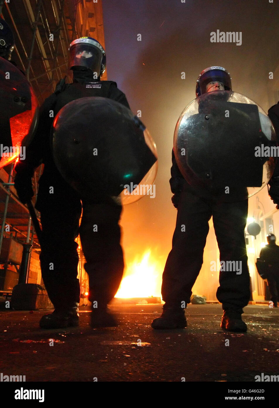 Riot police are seen in front of burning dustbins during the 'March for ...