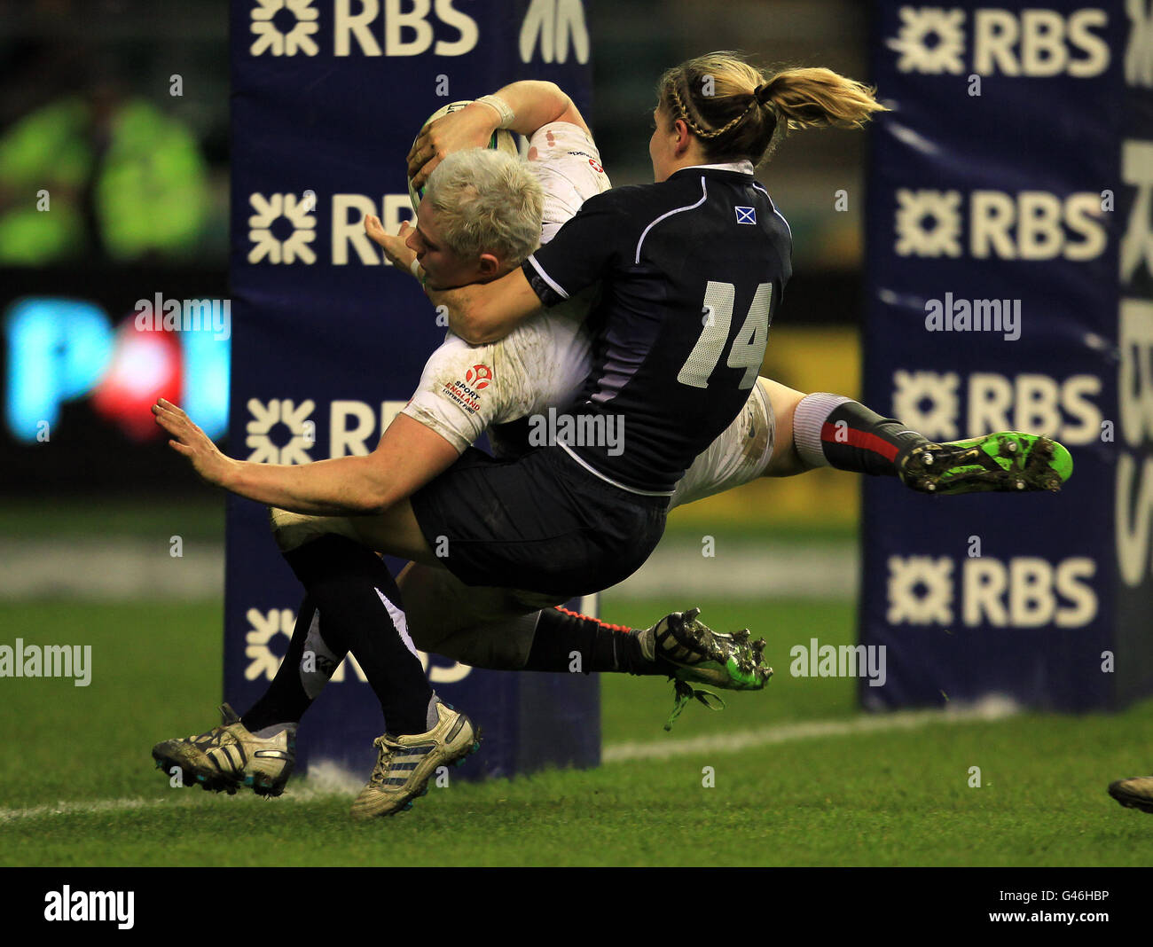 England's Heather Fisher scores a try as Scotland's Katy Green attempts ...