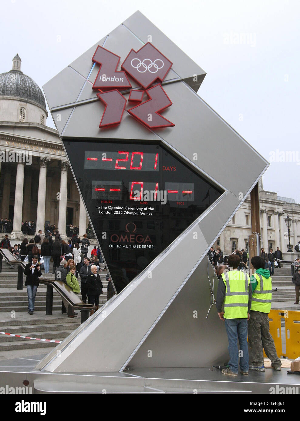 Workmen repair the Olympic Clock in Trafalgar Square, London, after it ...