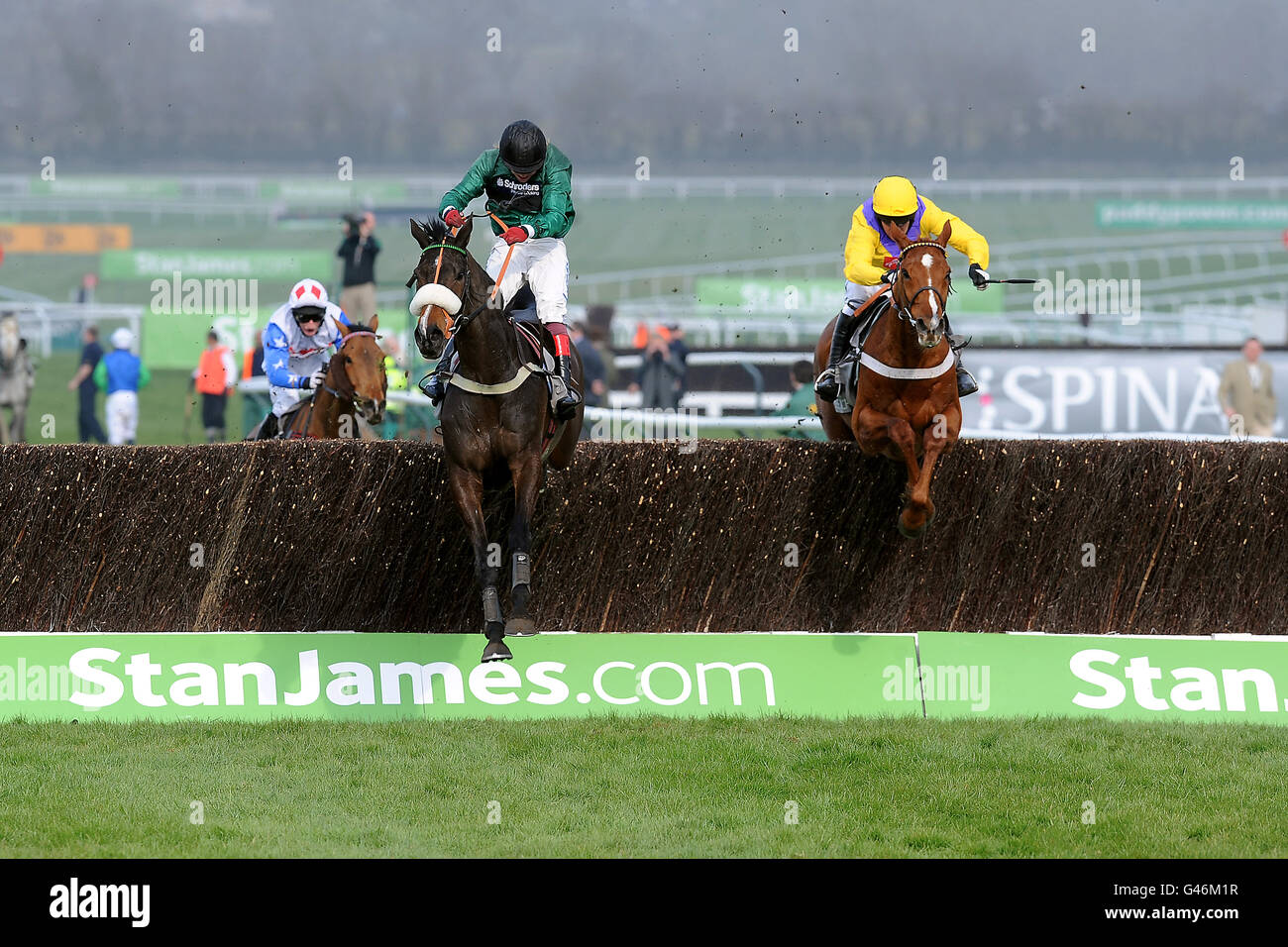 Jockey Robert Thornton (left) jumps the fence on his way to winning the ...