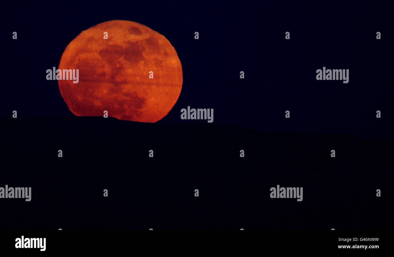 The moon, seen from Terminal 3 of Manchester Airport, rises from behind ...