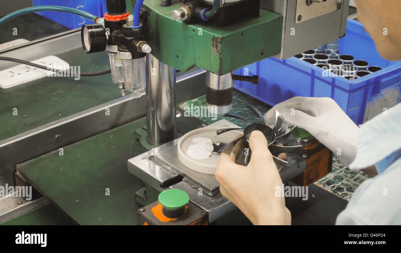 Worker in a factory of computer fans Stock Photo - Alamy