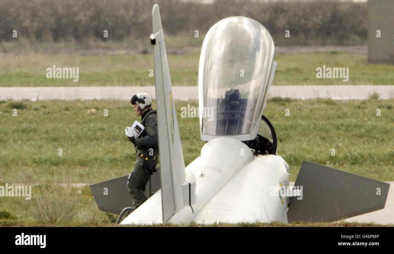 An RAF Typhoon jet fighter pilot climbs from the cockpit after landing ...