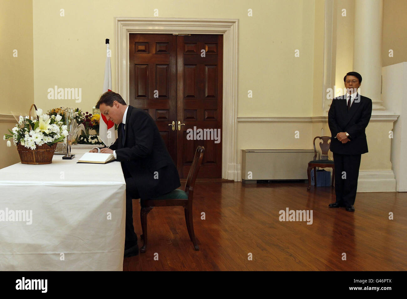 Prime Minister David Cameron signs a book of condolence, as Japan's ...