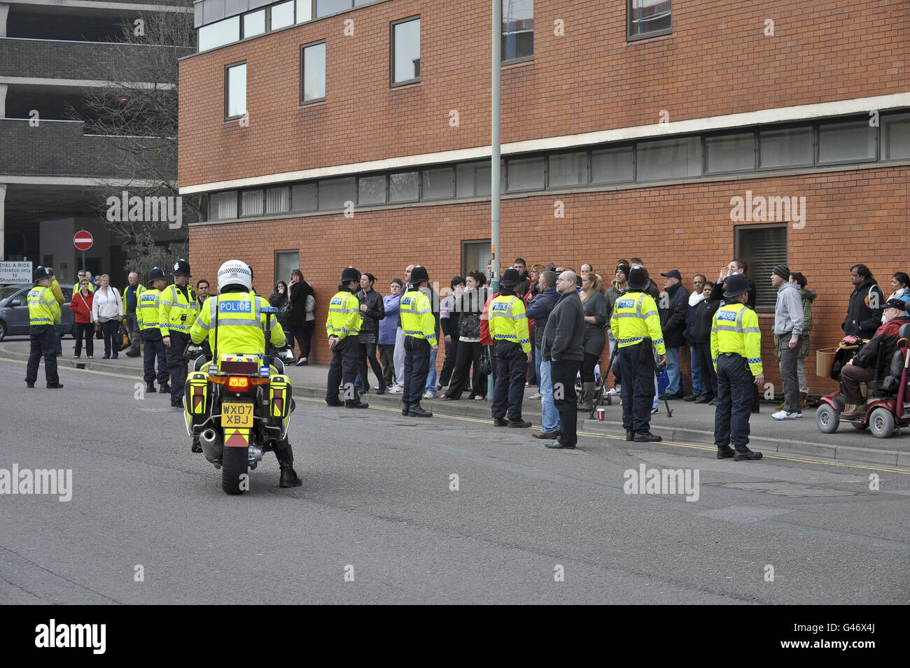 Police officers line the street outside Swindon Magistrates Court, as ...
