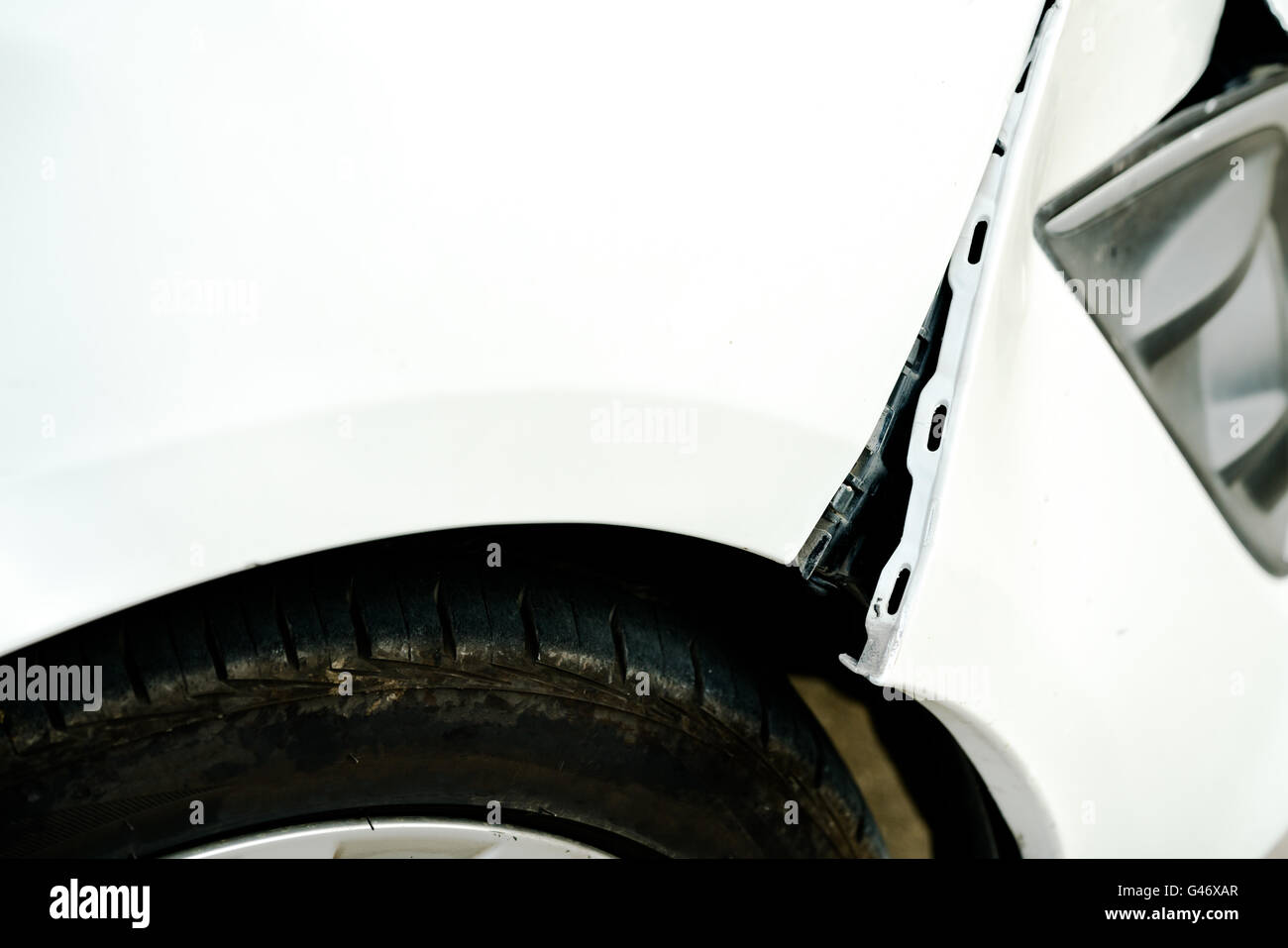 Dented and opening wound on a damaged white car Stock Photo - Alamy