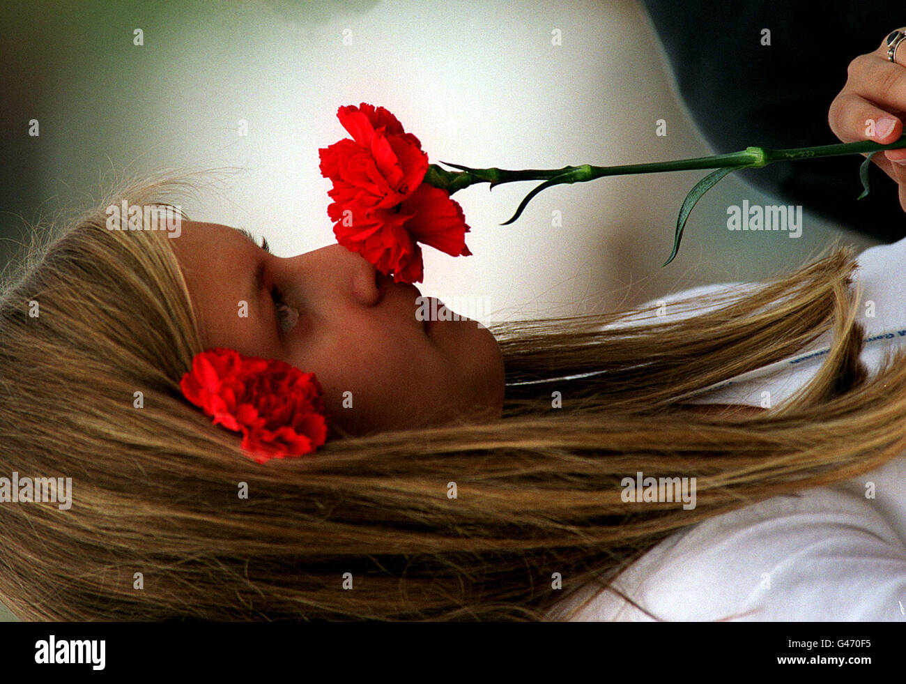 An American girl listens to the memorial service in Centennial Park ...