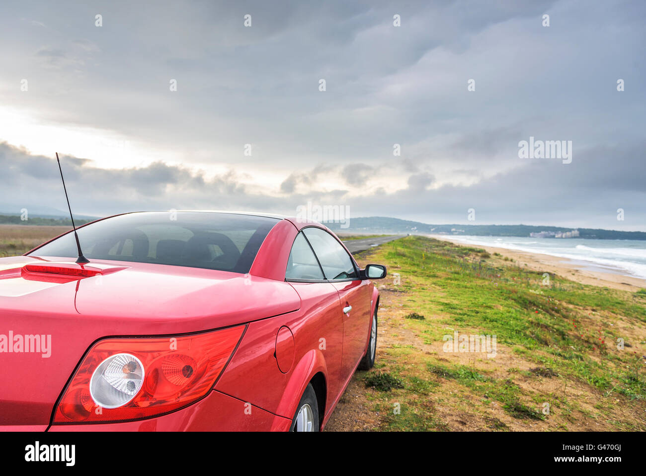 Red car on the beach Stock Photo - Alamy