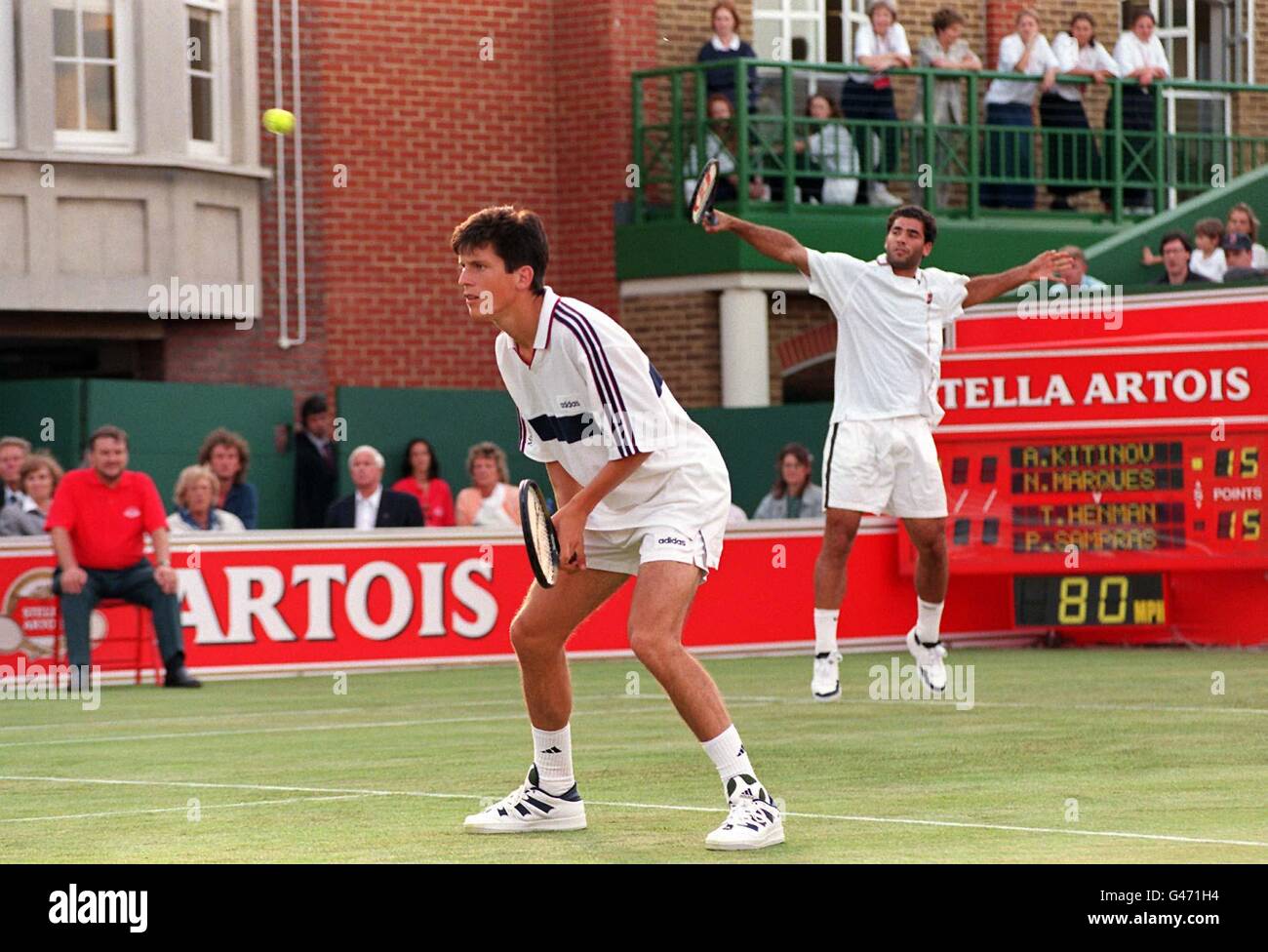 Pete Sampras returns serve over Tim Henman's head during their doubles ...