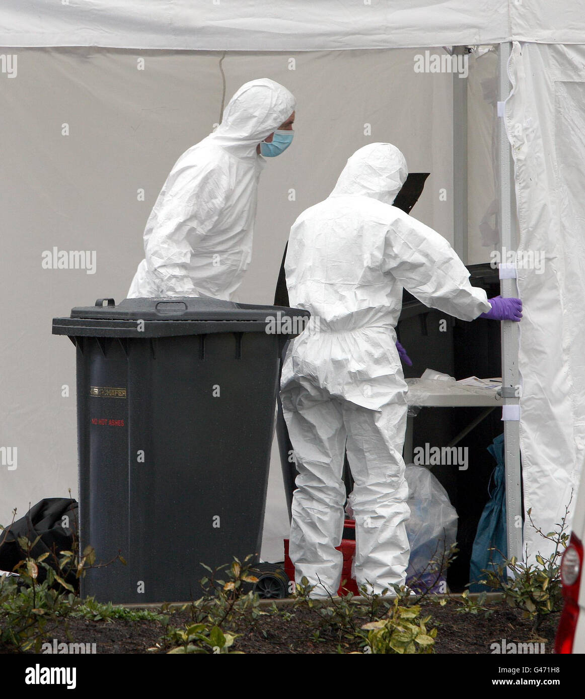Police forensic officers gather evidence outside the home of Police ... Police forensic officers gather evidence outside the home of Police ...