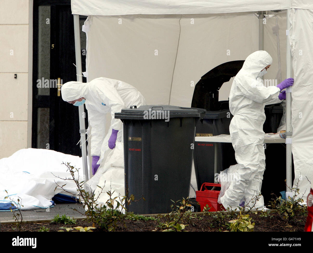 Police forensic officers gather evidence outside the home of Police ... Police forensic officers gather evidence outside the home of Police ...
