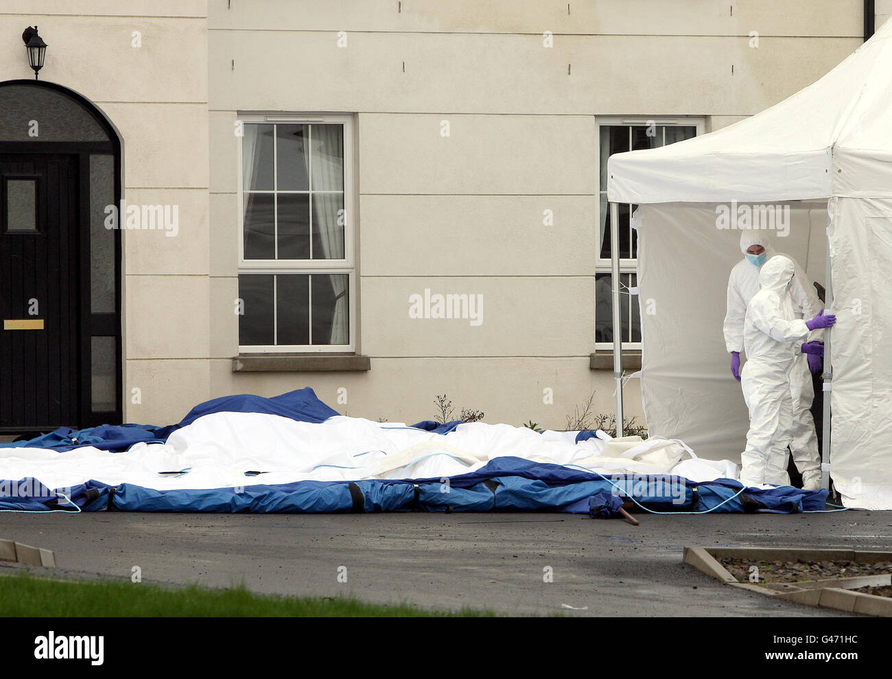 Police forensic officers gather evidence outside the home of Police ... Police forensic officers gather evidence outside the home of Police ...