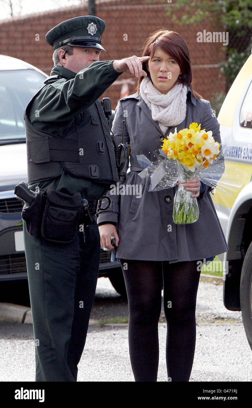 Neighbour Colleen Clements brings flowers outside the home of Police ...