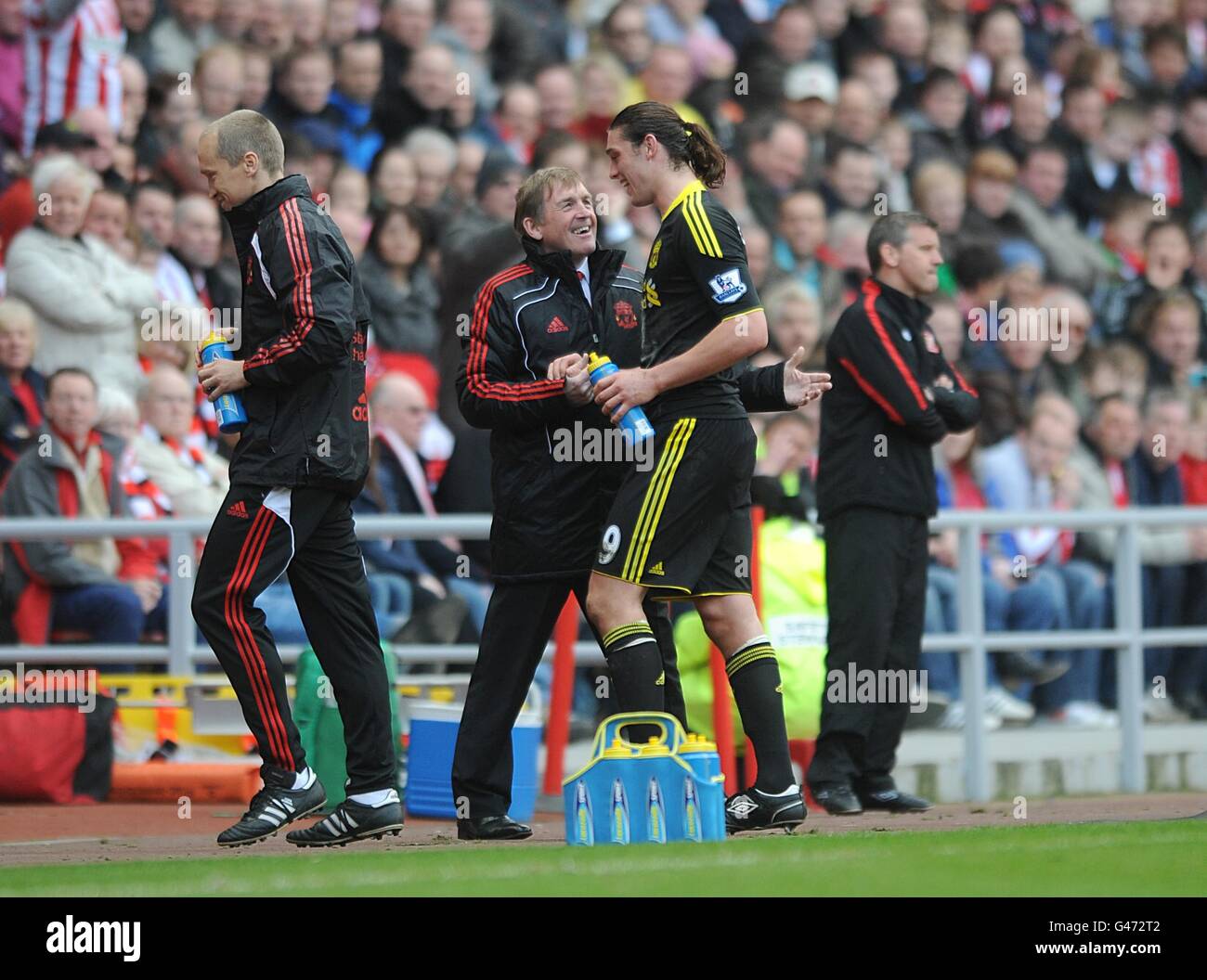 Liverpool's Andrew Carroll (centre right) is greeted by manager Kenny ...