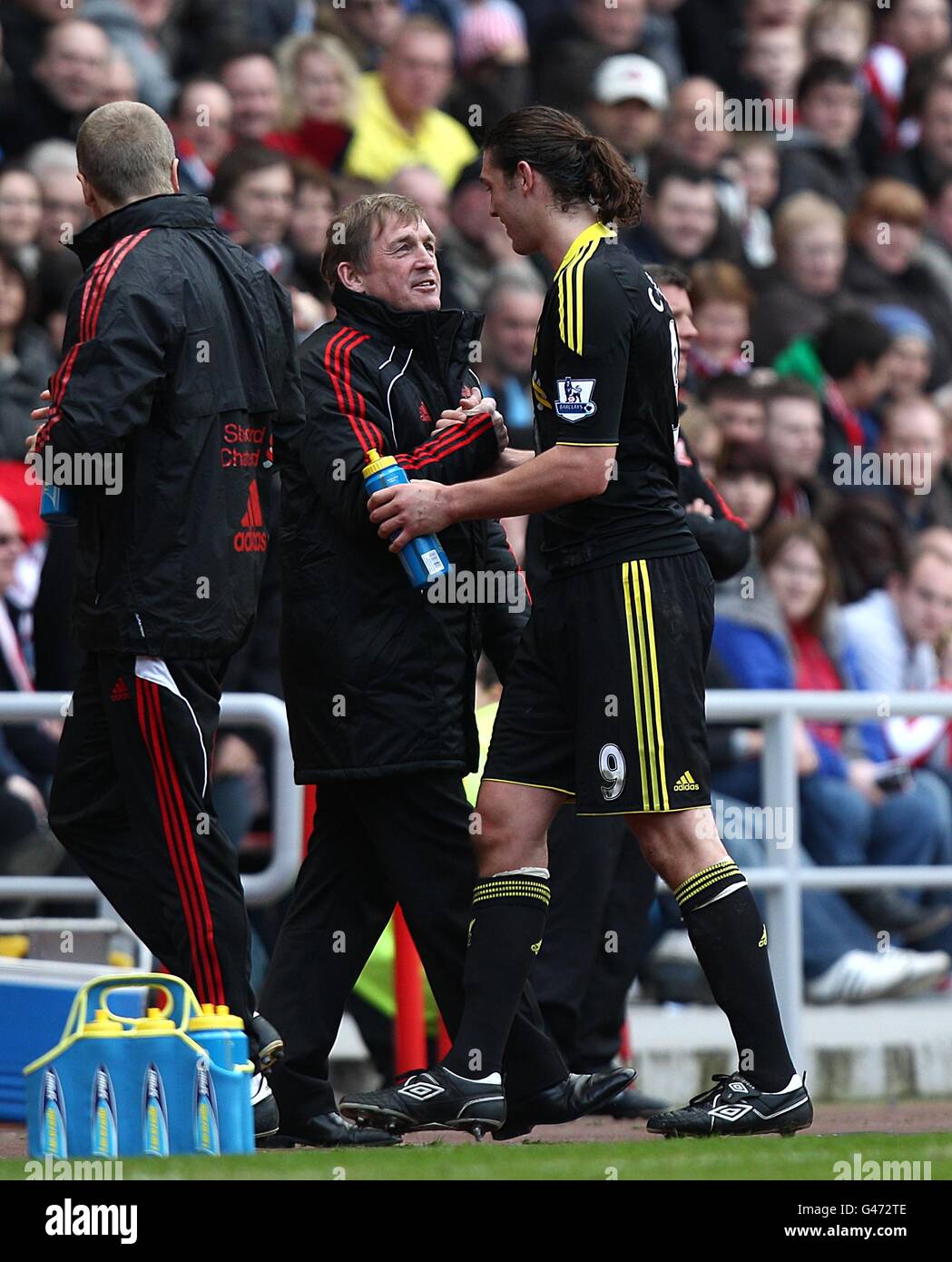 Liverpool manager Kenny Dalglish (left) greets Andrew Carroll (right ...