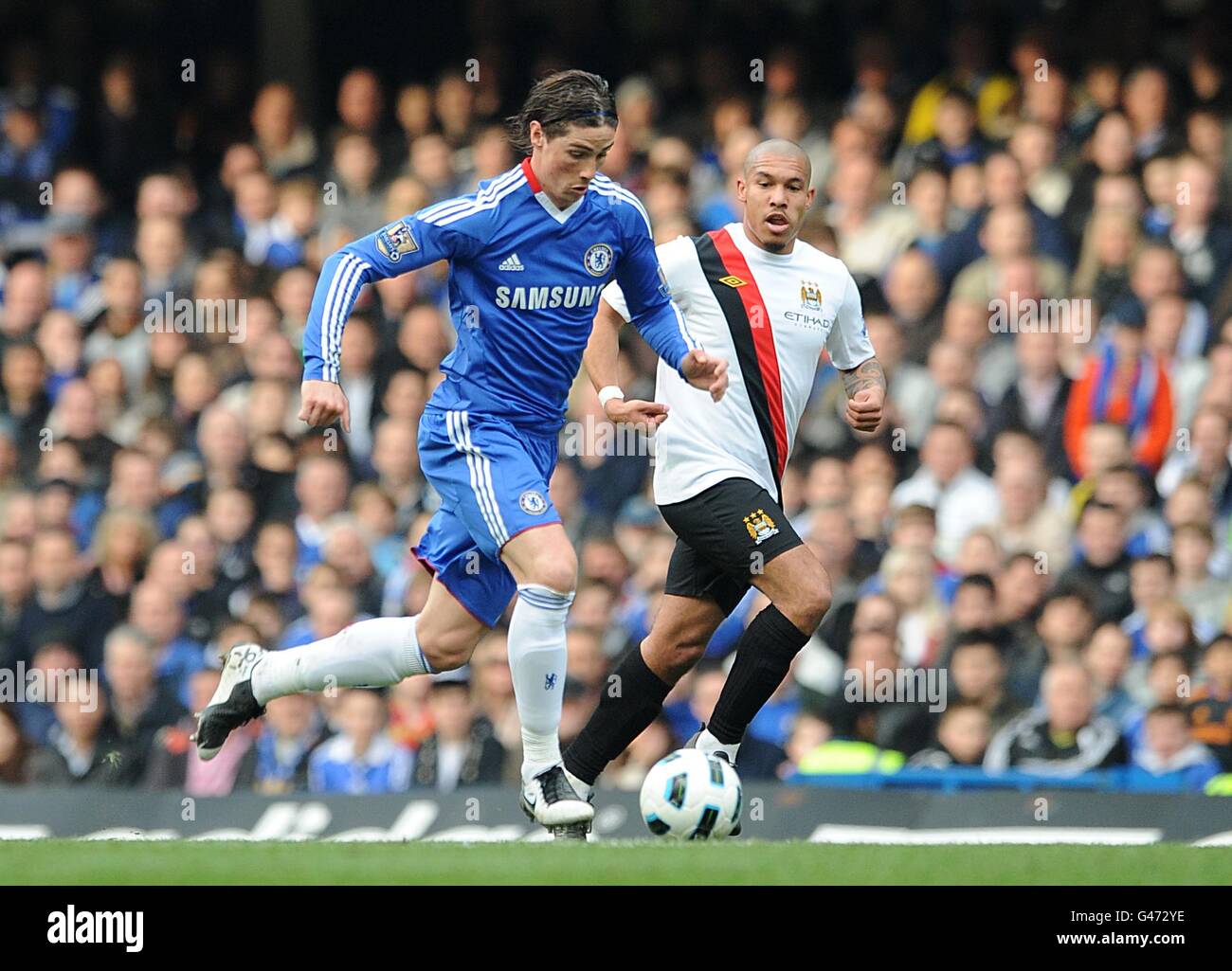 Chelsea's Fernando Torres (left) gets past Manchester City's Nigel De ...