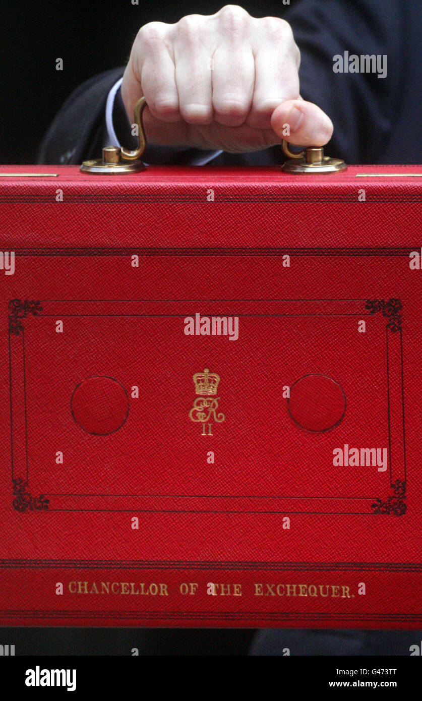 Chancellor of the Exchequer George Osborne holds up his ministerial red ...