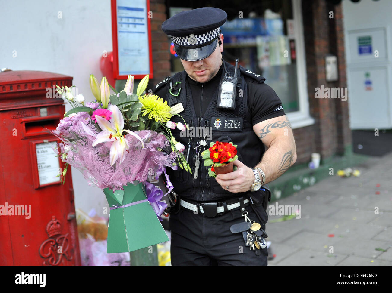 A police officer removes tributes from outside Suju nightclub in ...