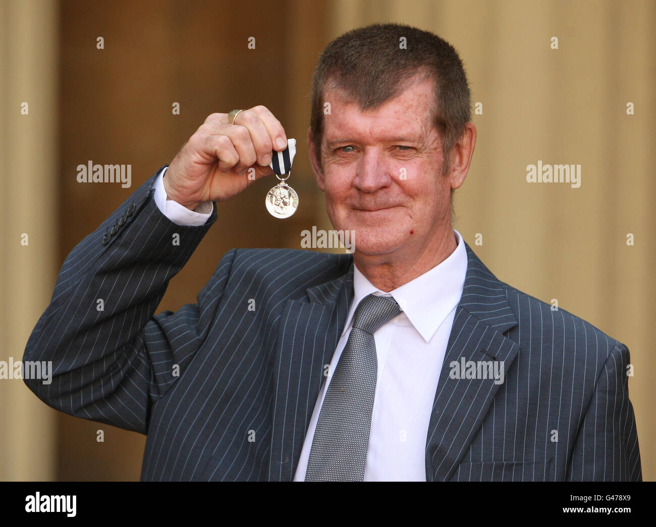 Constable Ivor MacGregor holds his Queen's Police Medal, awarded by the ...