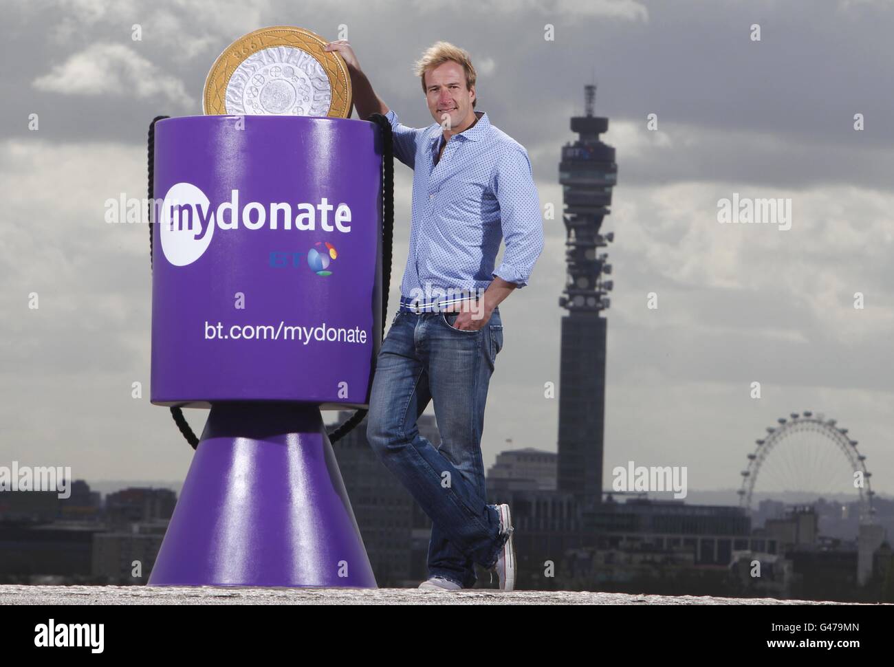 Television presenter Ben Fogle poses with a giant donation box on ...