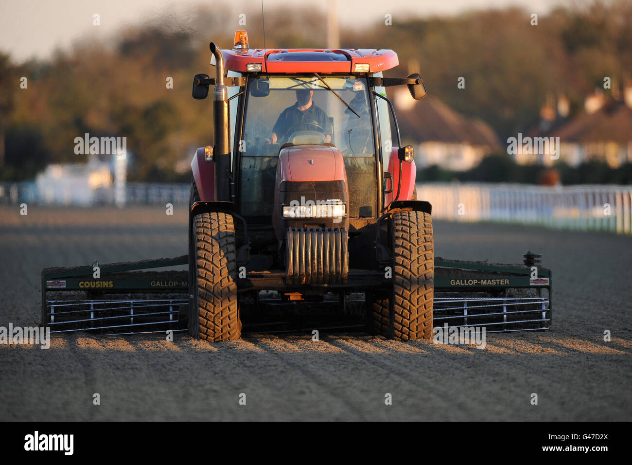 A tractor is driven down the all weather track at Kempton Park ...