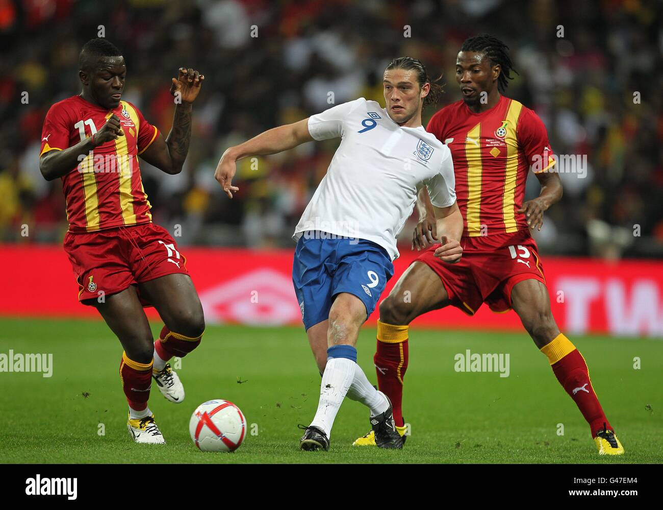 England's Andrew Carroll up against Ghana's Issac Vorsah (right) and ...
