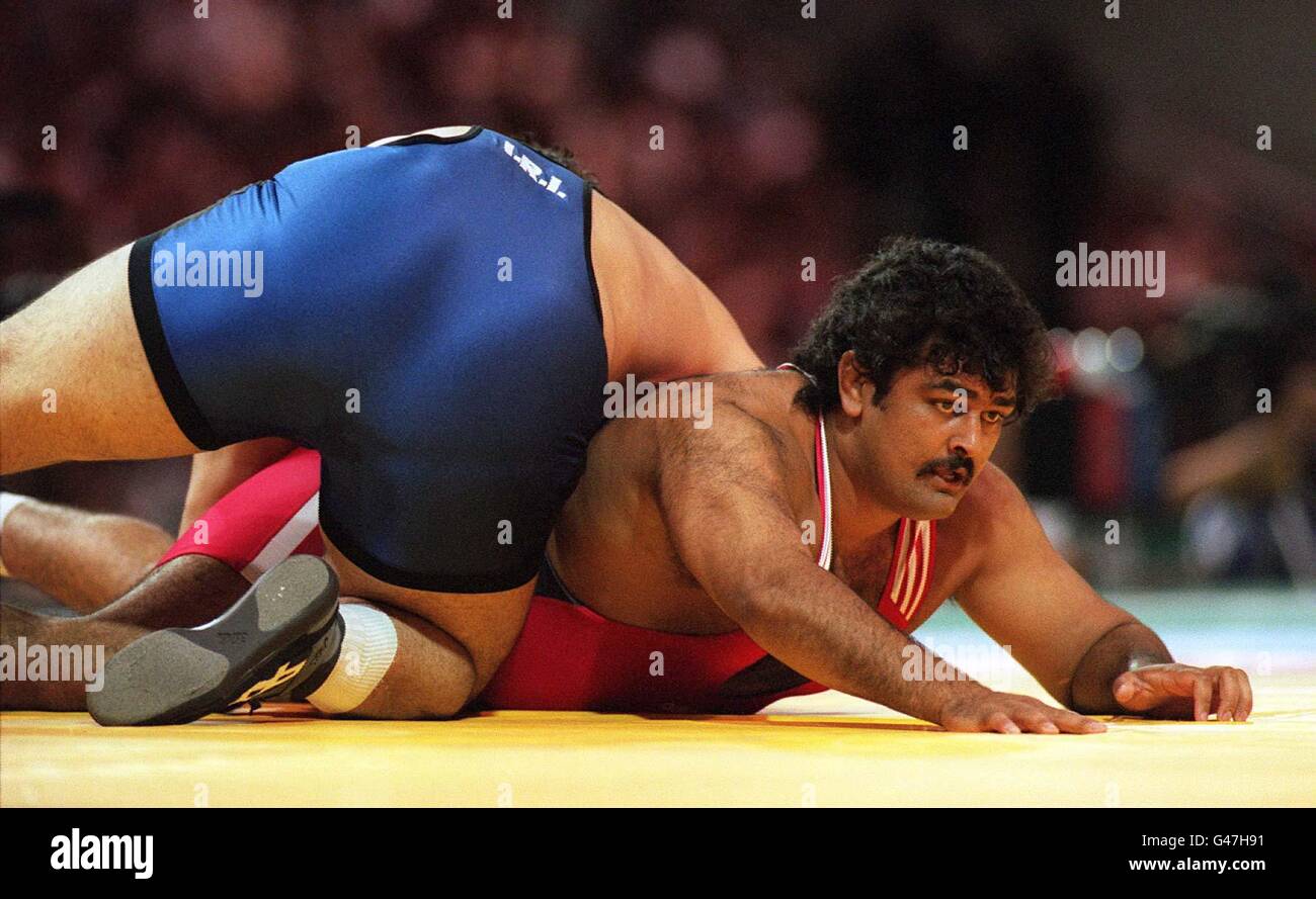 Amarjit Singh (GBR) (right), from Wolverhampton, is pinned down by ...