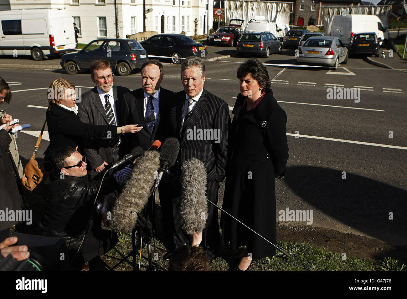 First Minister Peter Robinson (second right) speaking to the media at ...