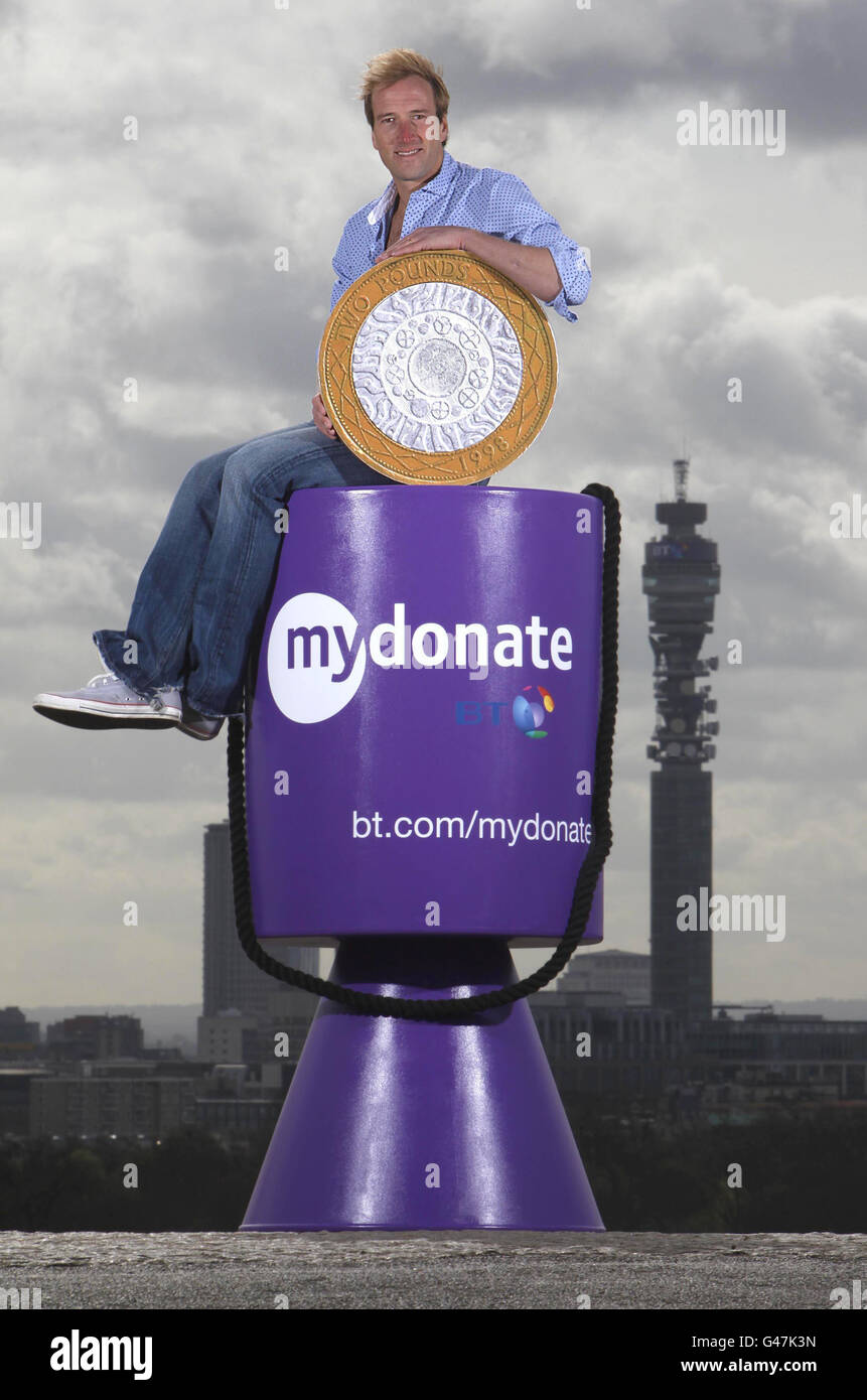 Television presenter Ben Fogle poses with a giant donation box on ...
