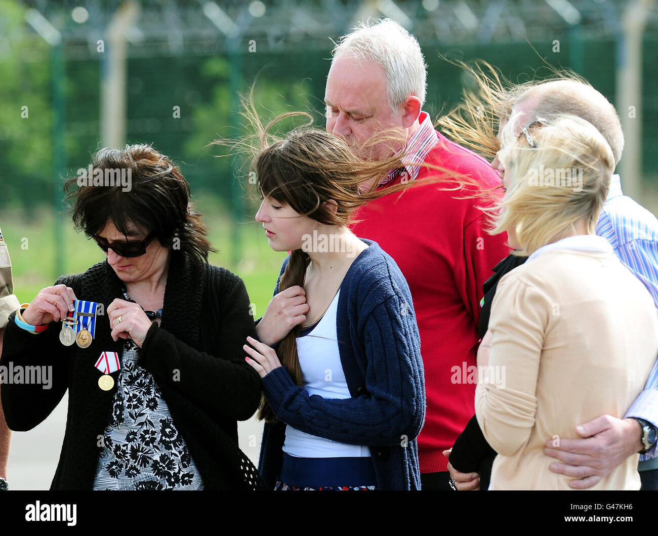 Members of Lance Corporal Liam Tasker's family look on as his mother ...