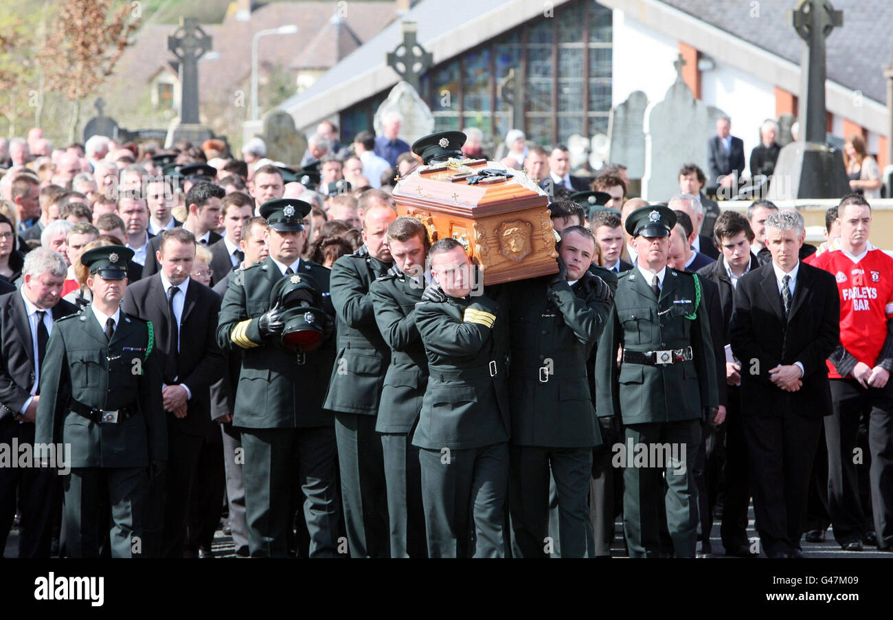 The coffin of PSNI Constable Ronan Kerr is carried through his home ...