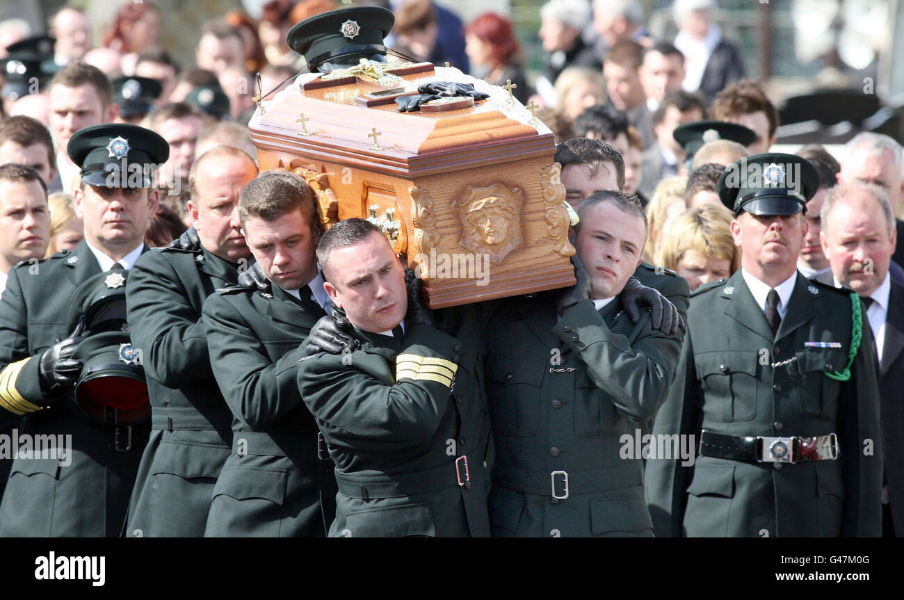 The coffin of PSNI Constable Ronan Kerr is carried through his home ...