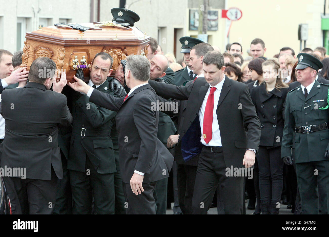 The coffin of PSNI Constable Ronan Kerr is handed over to the police ...