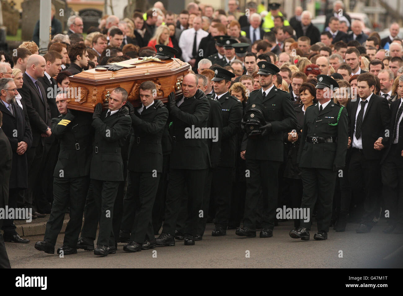 The coffin of PSNI Constable Ronan Kerr is carried through his home ...