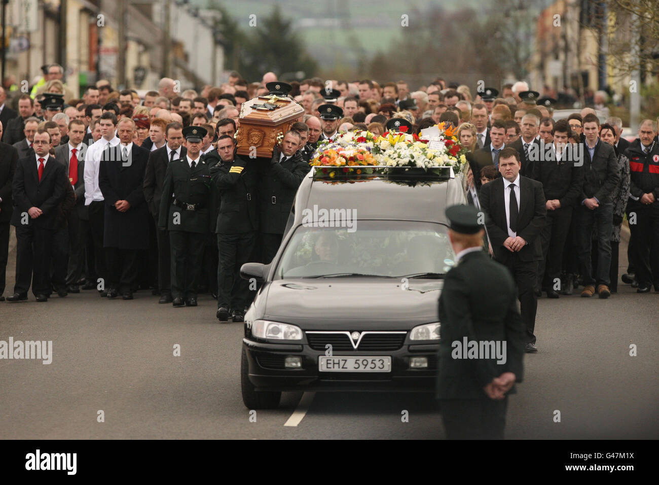 The coffin of PSNI Constable Ronan Kerr is carried through his home ...