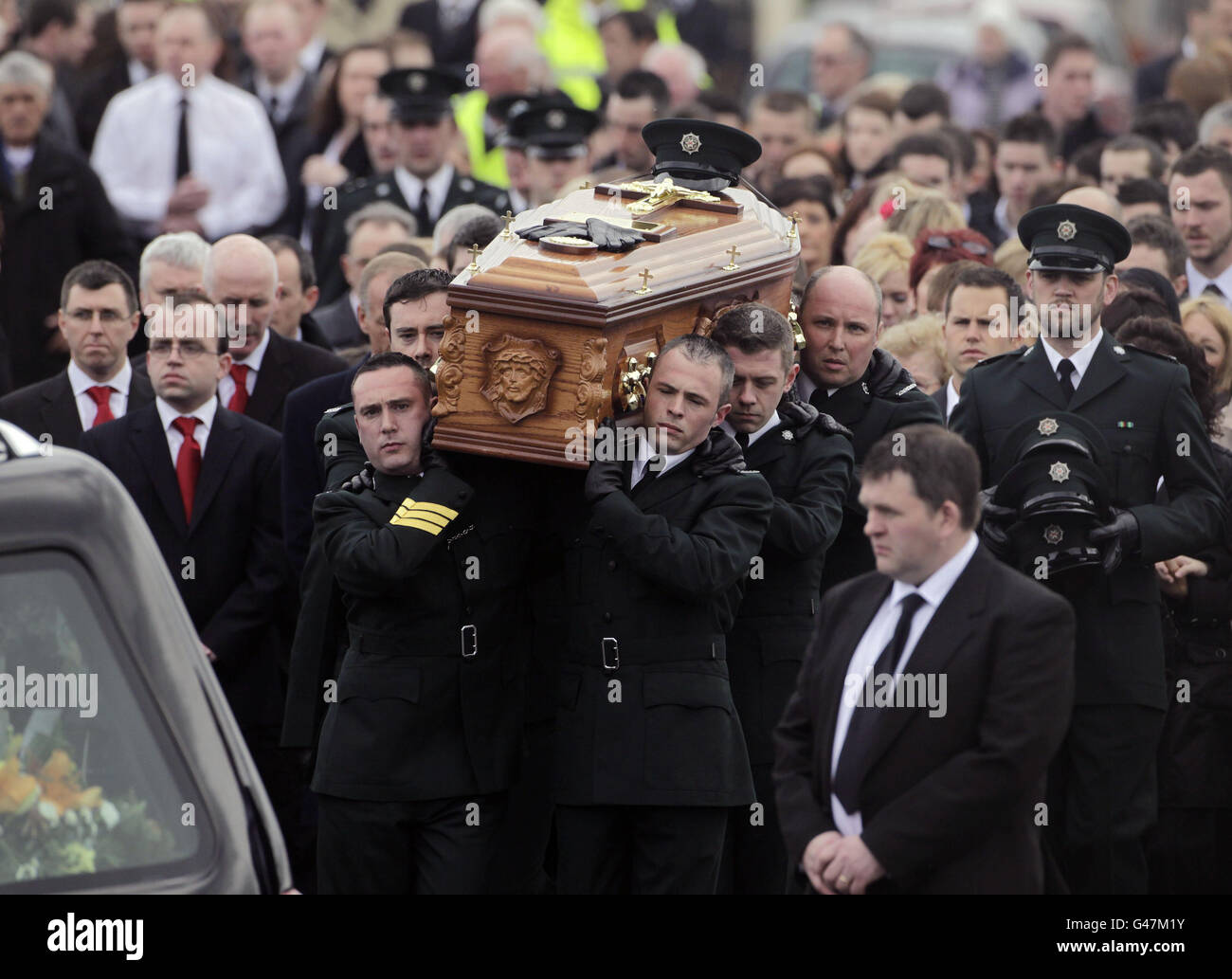 The coffin of PSNI Constable Ronan Kerr is carried through his home ...