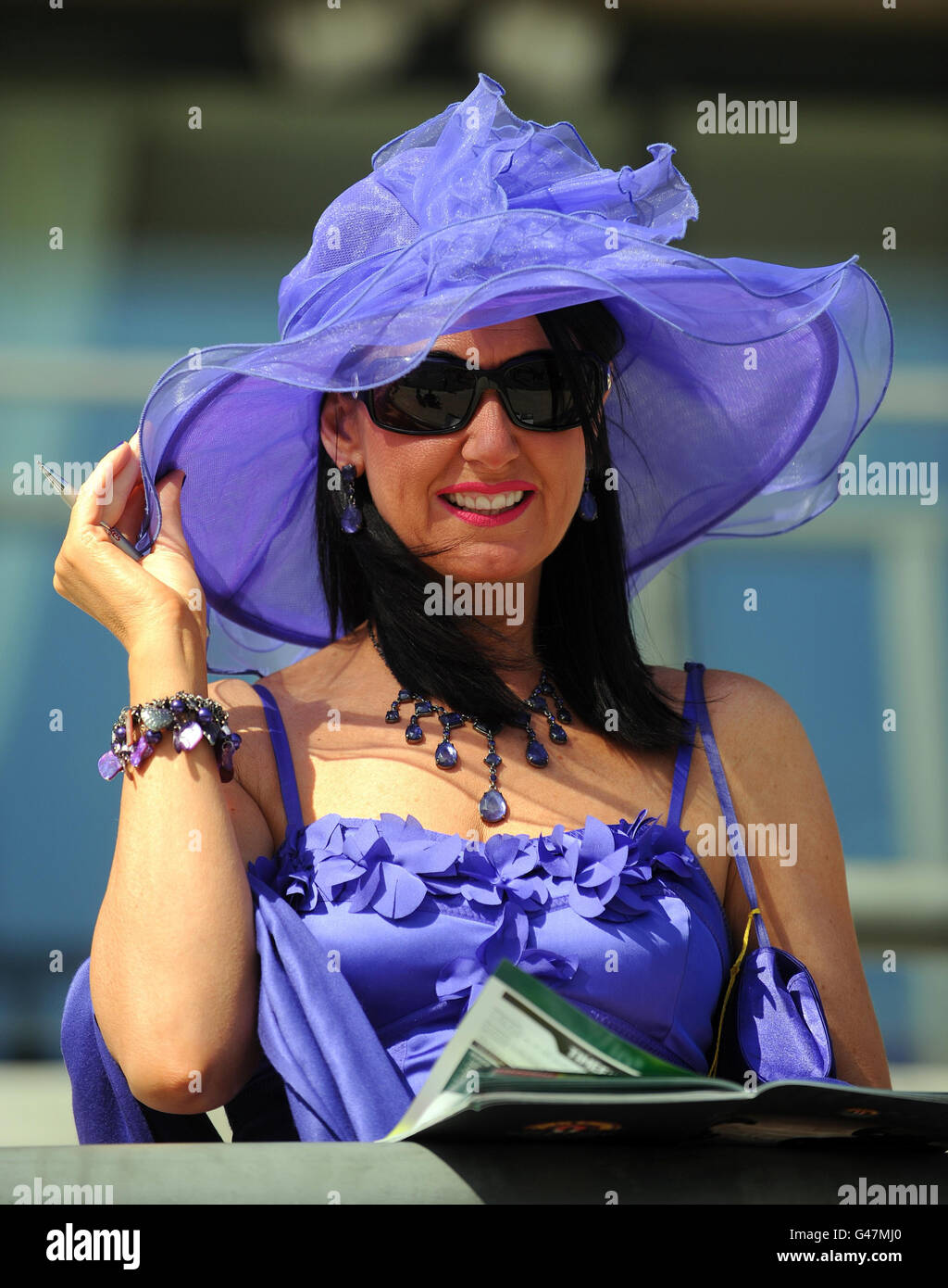 Racegoer the card during grand national day at aintree racecourse hi ...