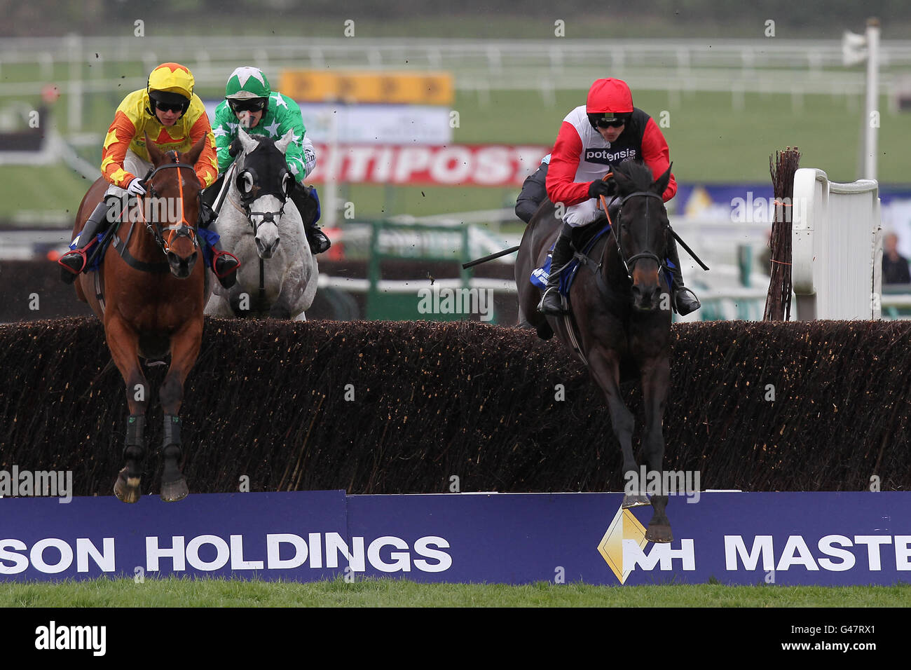 Jockey Ruby Walsh on Poquelin (right) jumps ahead of Kieran Burke (left ...