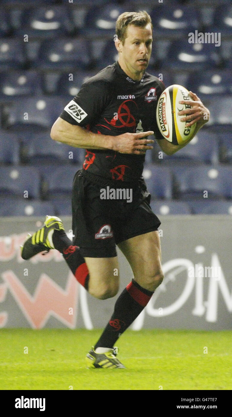 Edinburgh's Chris Paterson breaks through the Aironi line to score a ...