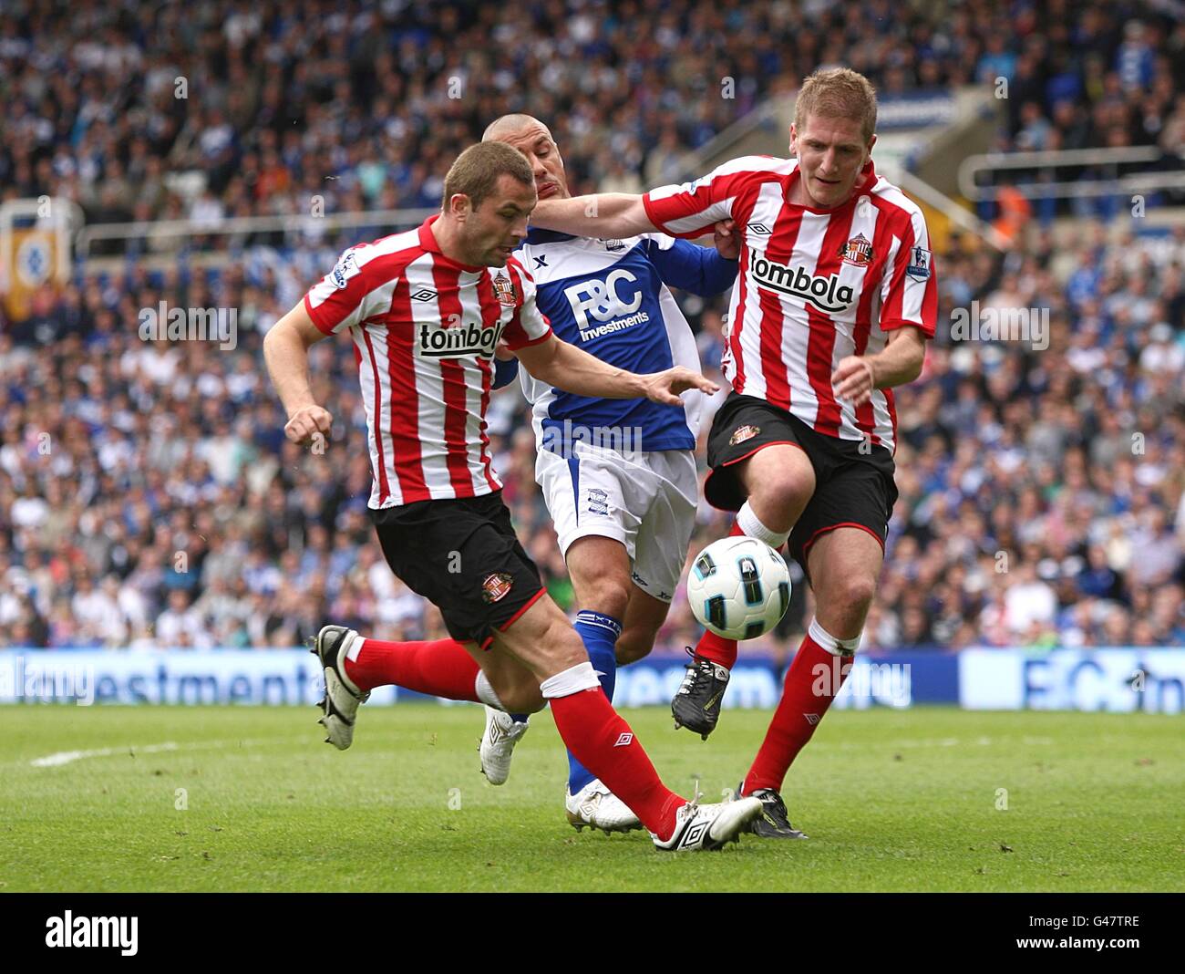 Sunderland's Michael Turner (right) and Phillip Bardsley (left) battle ...