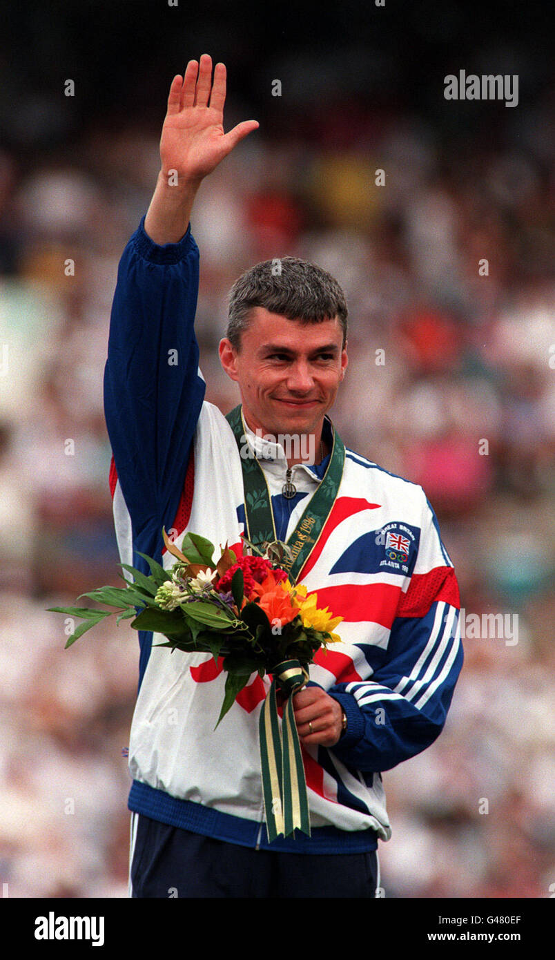 Britain's Jonathan Edwards waves to the crowd in the Olympic Stadium ...