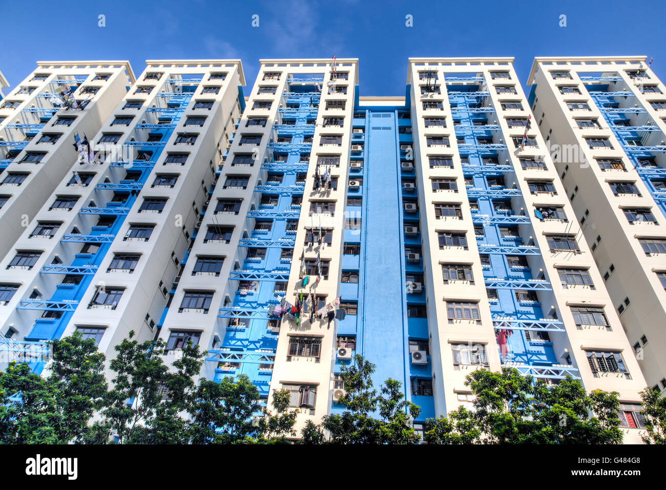 A typical Singapore highrise public housing estate against a blue sky ...
